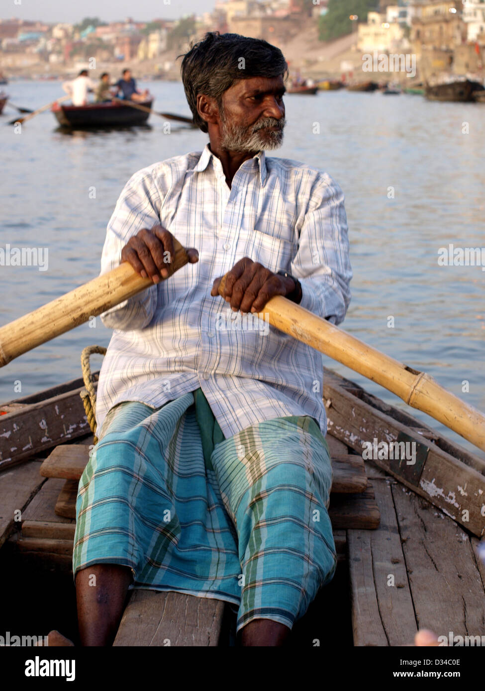 Man rowing boat on Ganges in Varanasi, India Stock Photo - Alamy