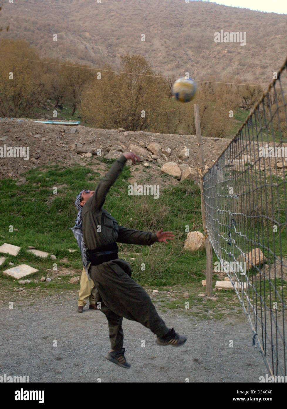 Guerrilla combatant of the PKK (Kurdish Workers Party) playing ...