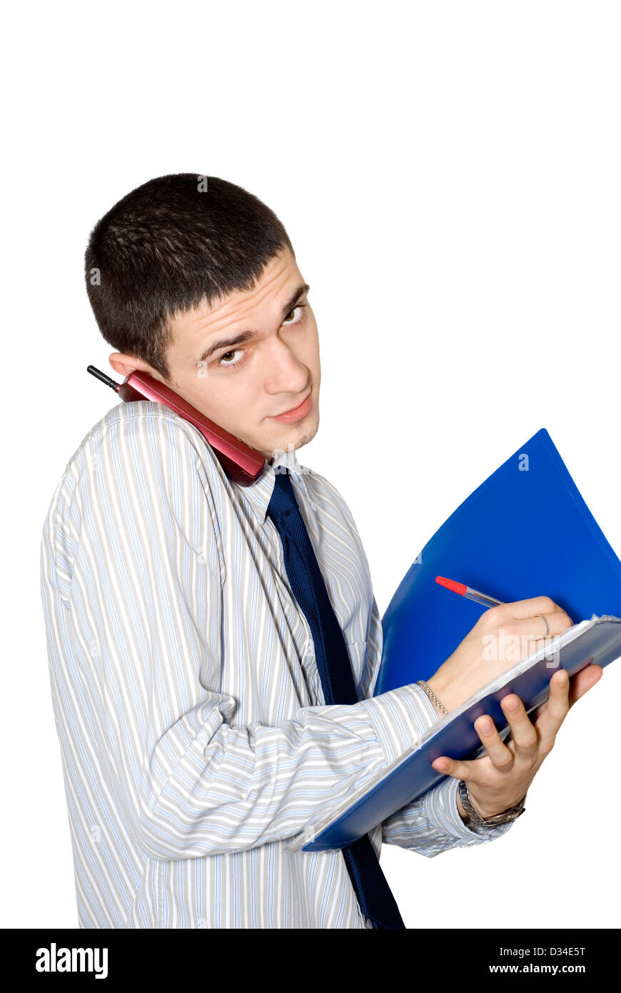 The young man writes and simultaneously speaks by phone Stock Photo - Alamy