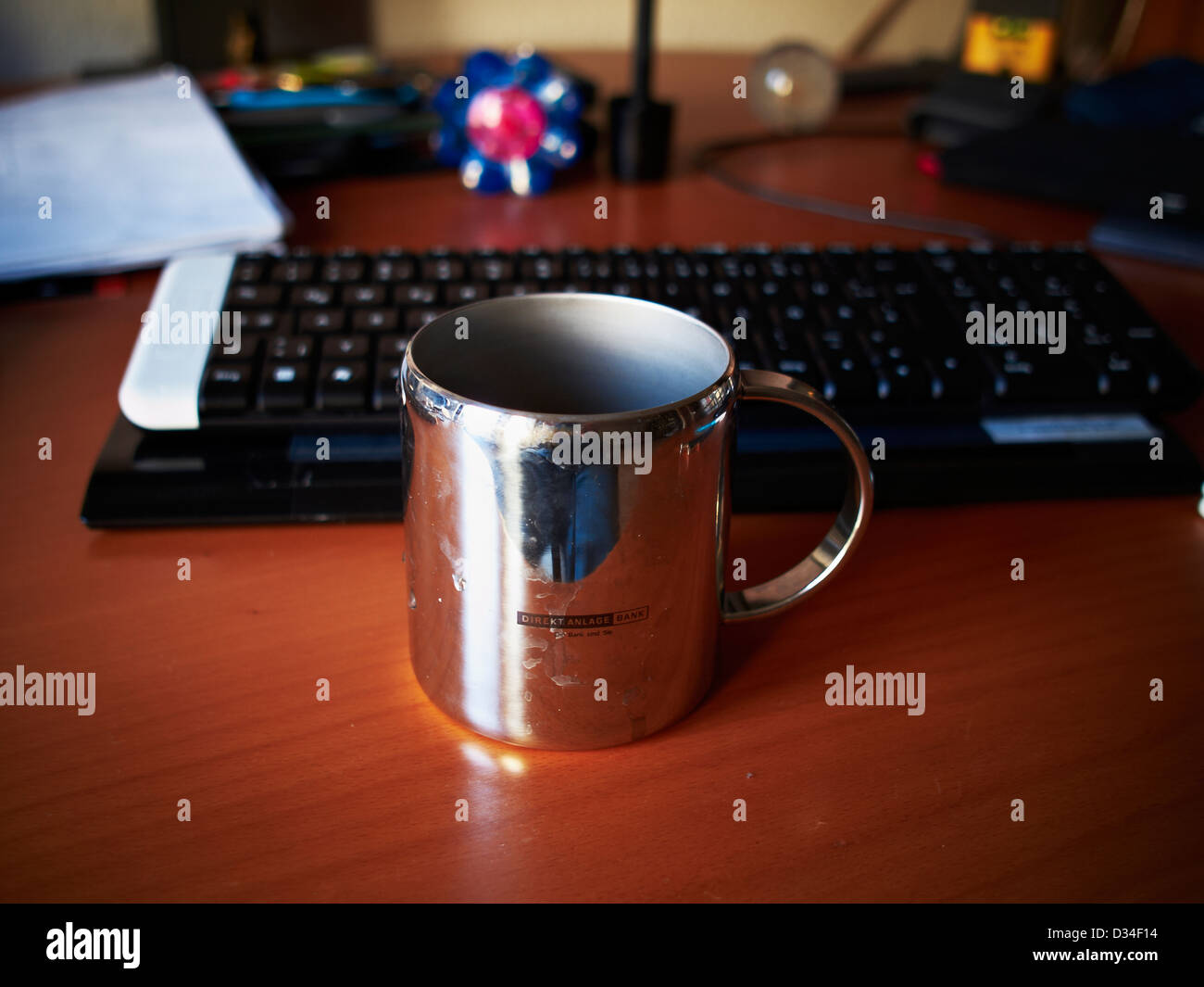 Office desk with stainless steel mug Stock Photo - Alamy