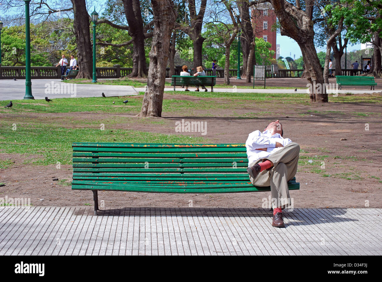 Buenos Aires Argentina. A man taking a lunchtime siesta nap on a park ...