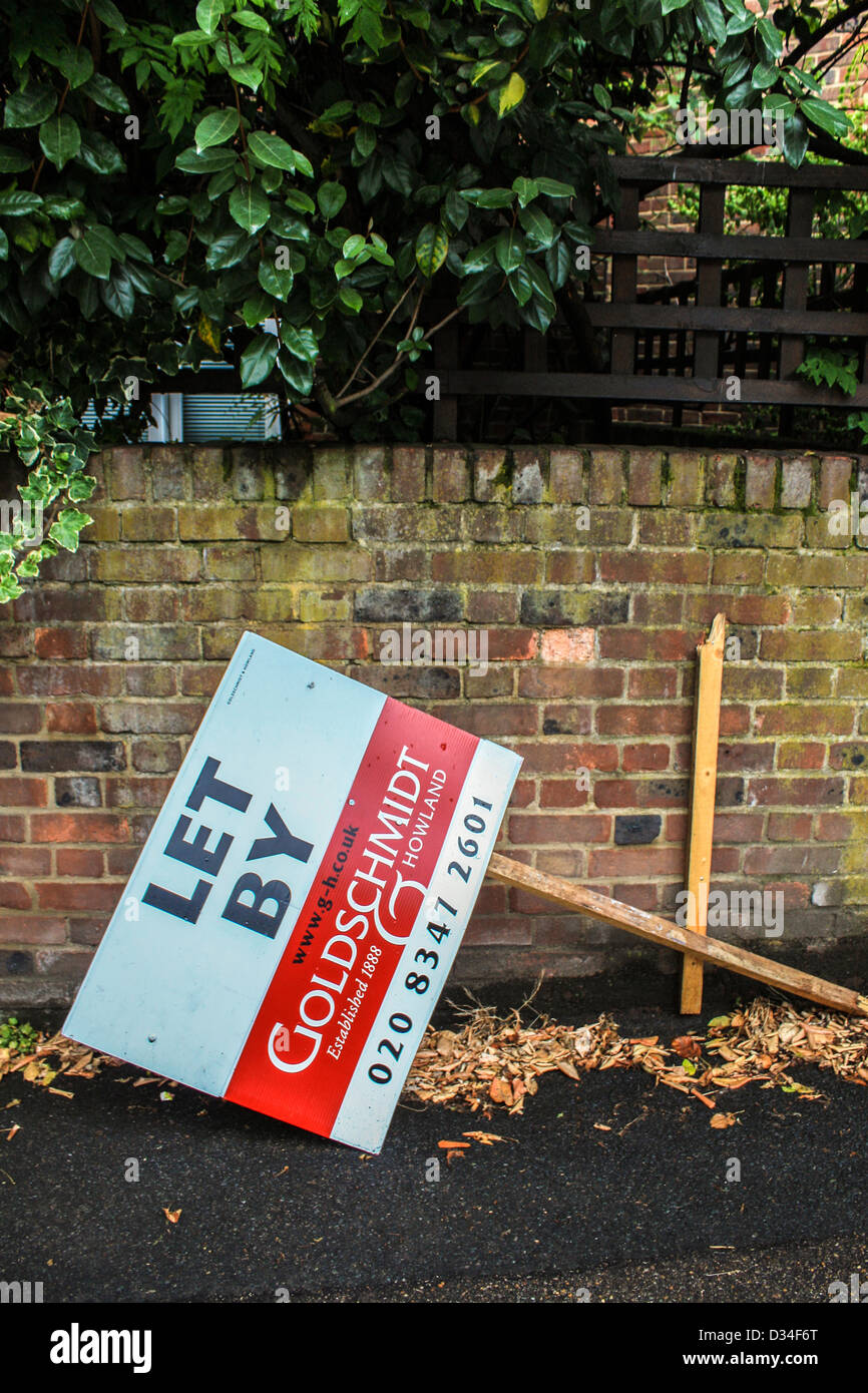 fallen "Let By" sign, north London, UK Stock Photo - Alamy