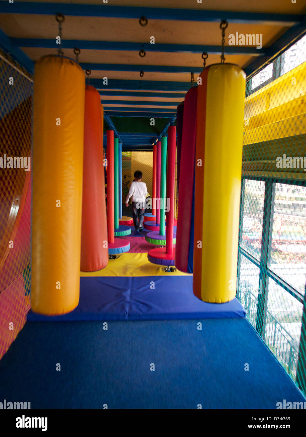 Children's playroom. Child runs through some padded bumpers in a giant ...