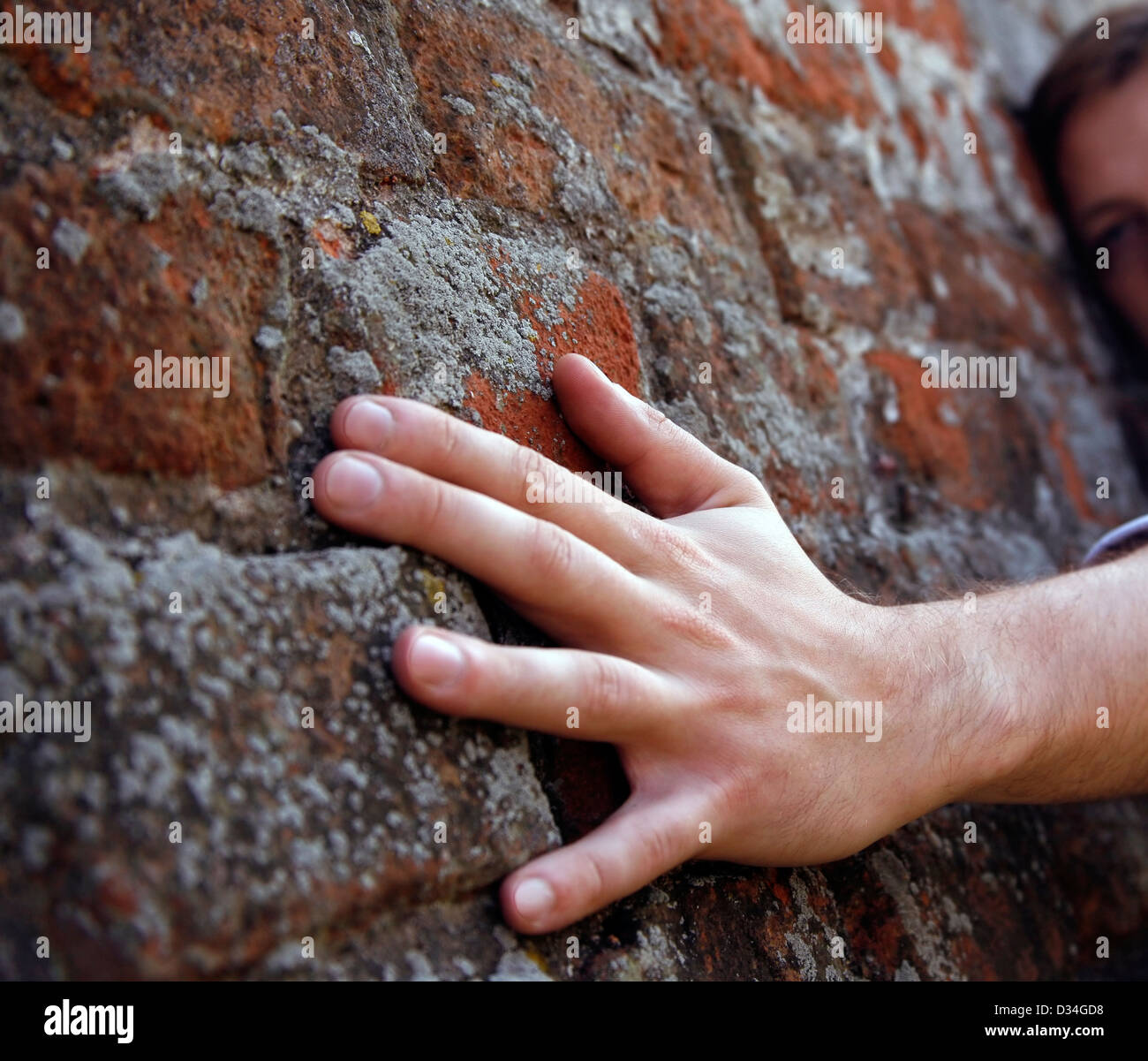 Hand of the man on a background of a brick wall Stock Photo - Alamy