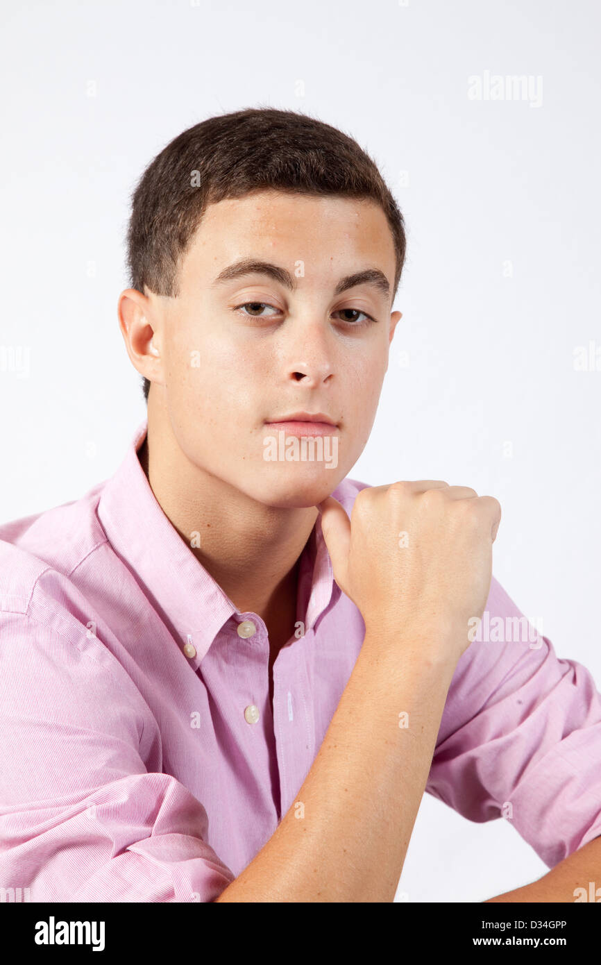 Teenage boy looking at the camera with a thoughtful, pensive look and ...