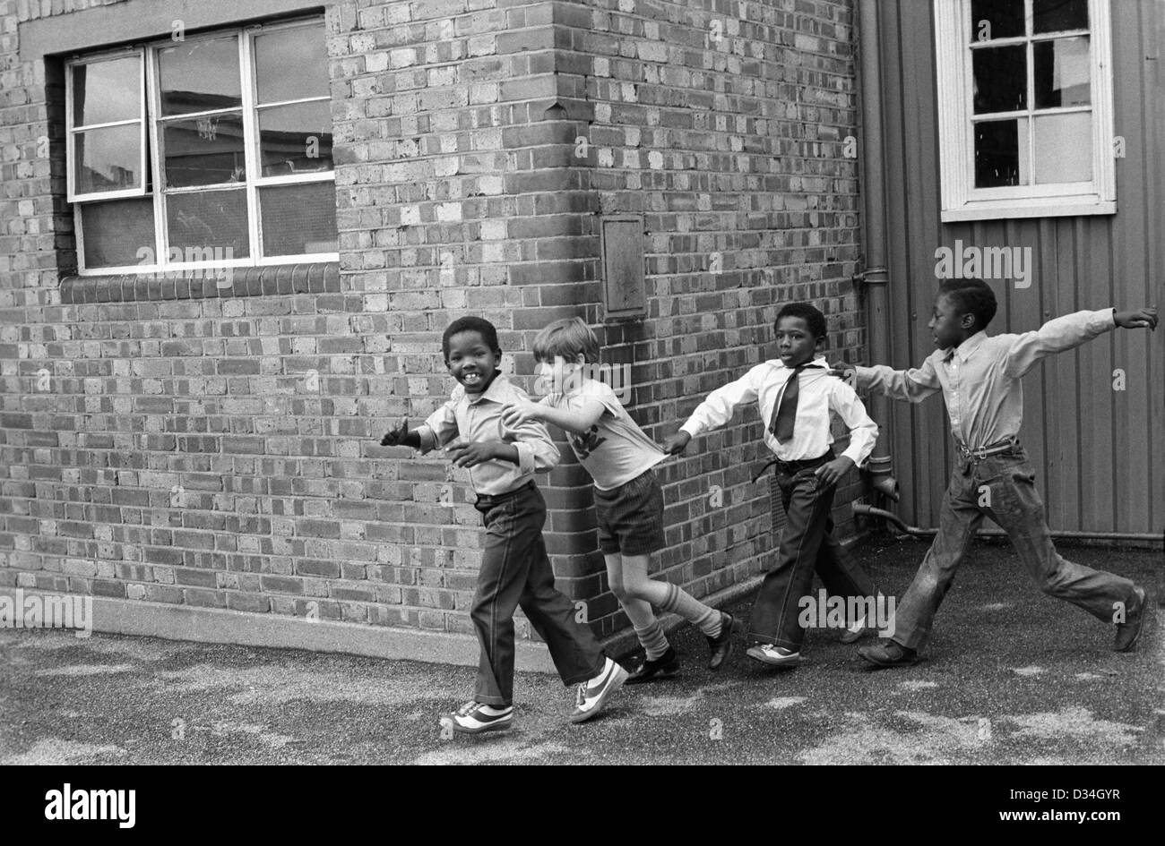 White and black children playing hi-res stock photography and images ...