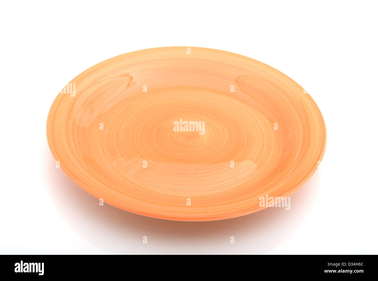 empty orange plate on plain background Stock Photo - Alamy