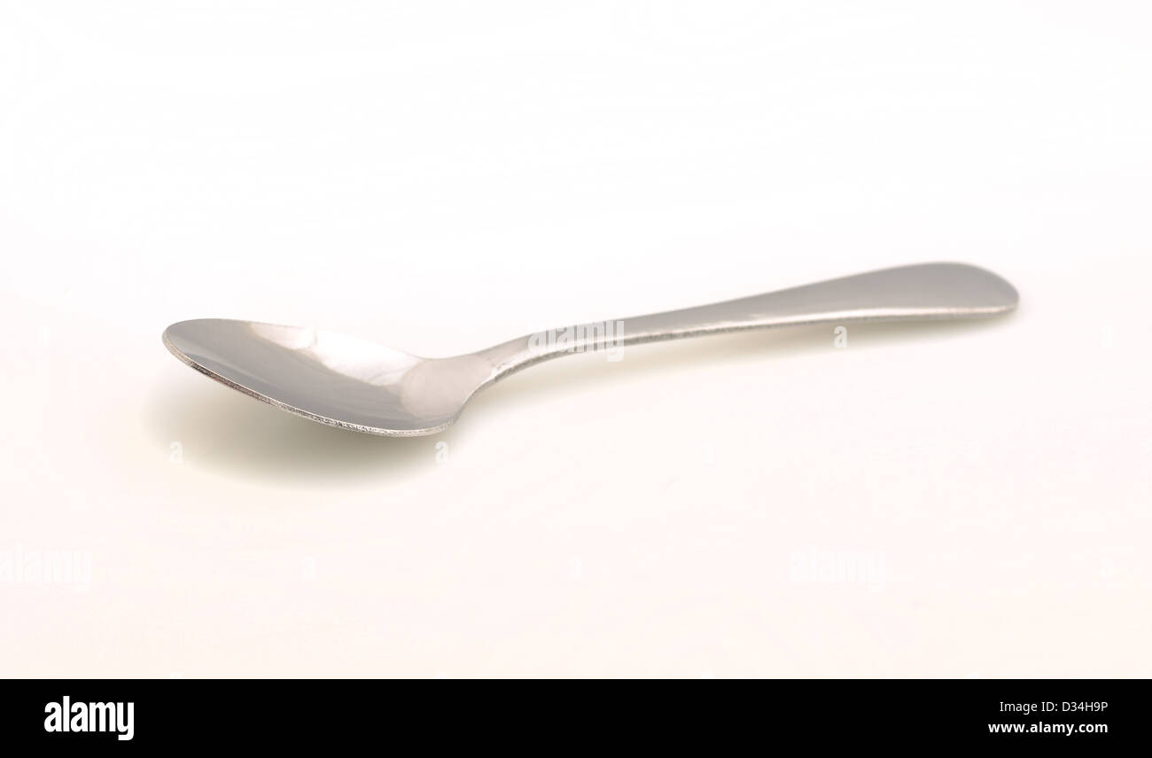 Single silver spoon on white background Stock Photo - Alamy