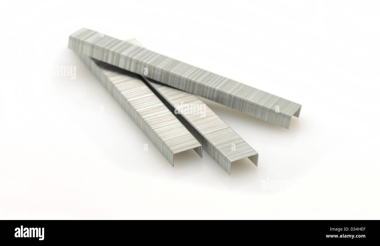 three rows of staples for stapler on white background Stock Photo - Alamy