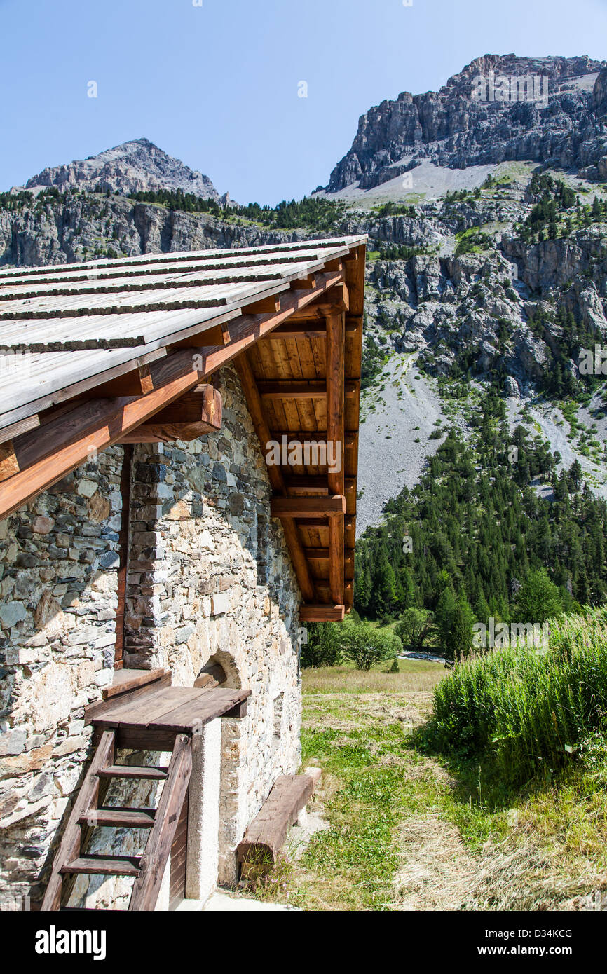 Swiss Alps, mountain cottage made of stone and wood, summer season ...