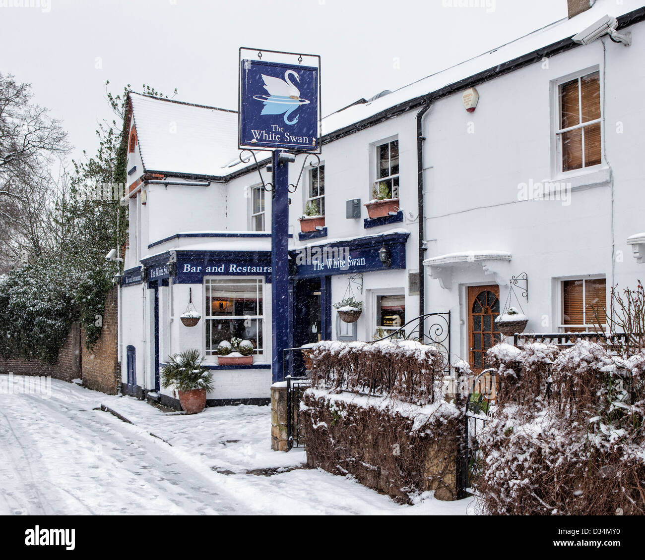"The White Swan" typical English pub. Building exterior and sign during ...
