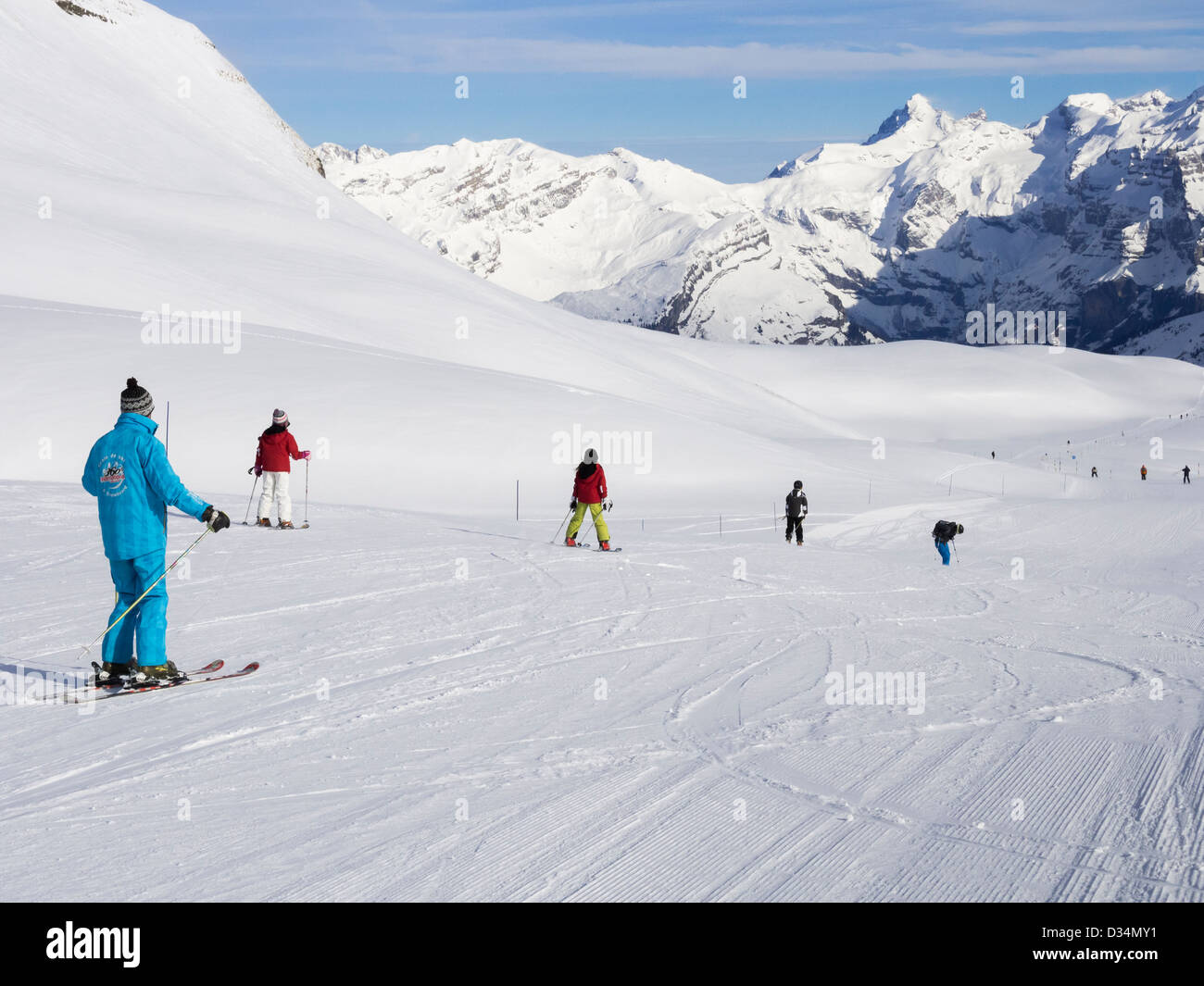 Skiers skiing down 14 km blue snow slope Les Cascades ski slope in Le ...