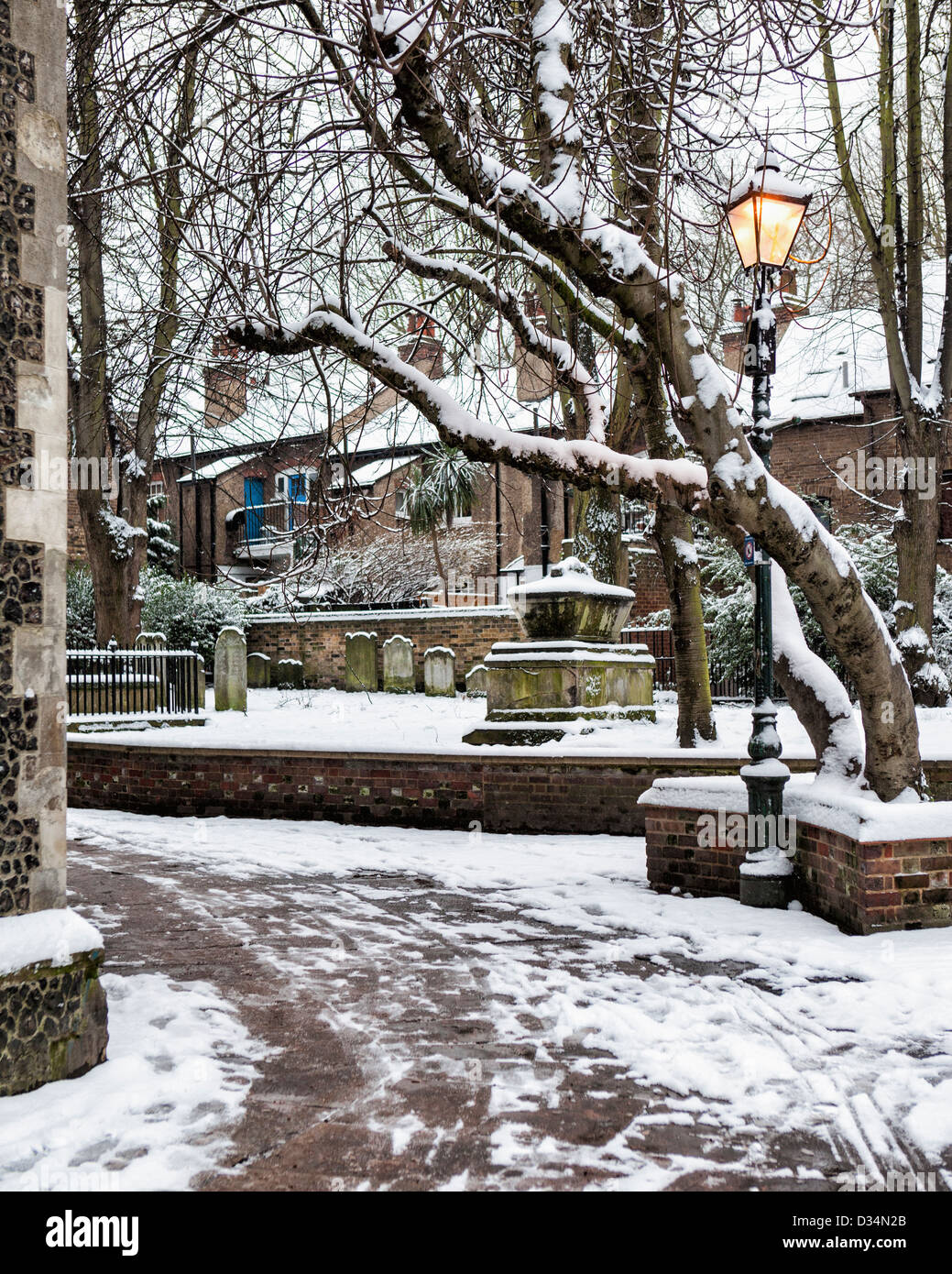 Snow covered graveyard and path of St Mary Magdalene church in Winter ...