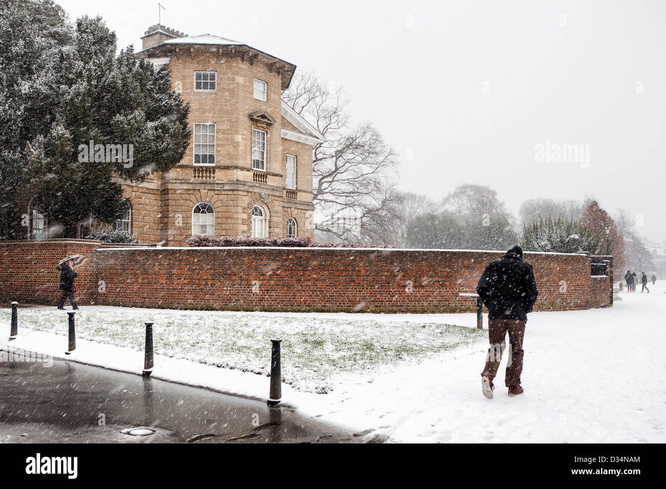 Man walking through falling snow near Asgill House on the Banks of the ...
