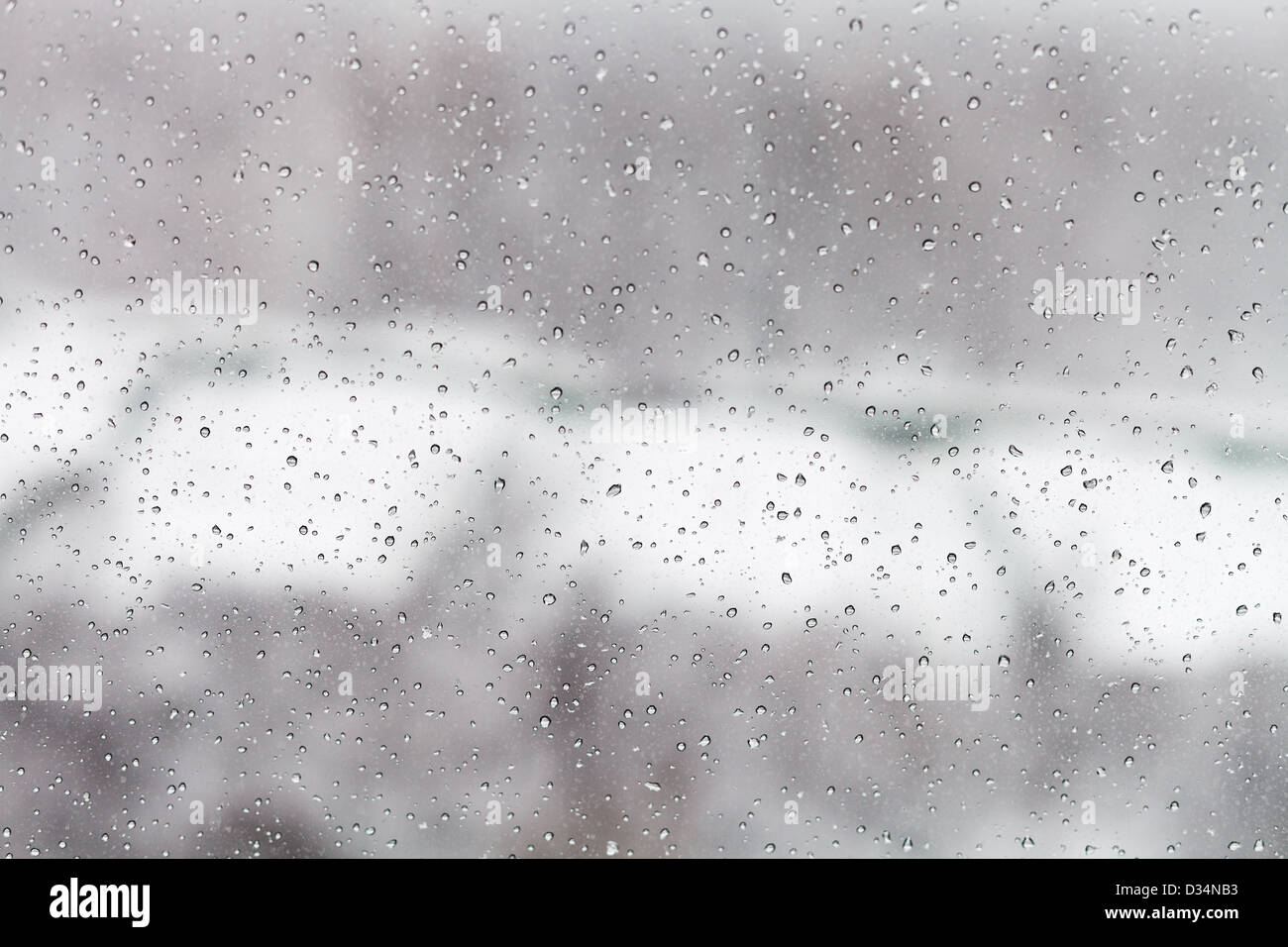 raindrops on glass window with winter urban background Stock Photo - Alamy
