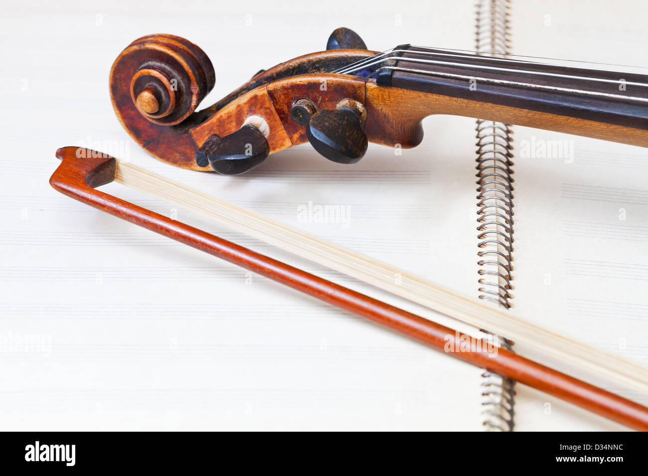 fiddle bow and scroll on music book close up Stock Photo - Alamy