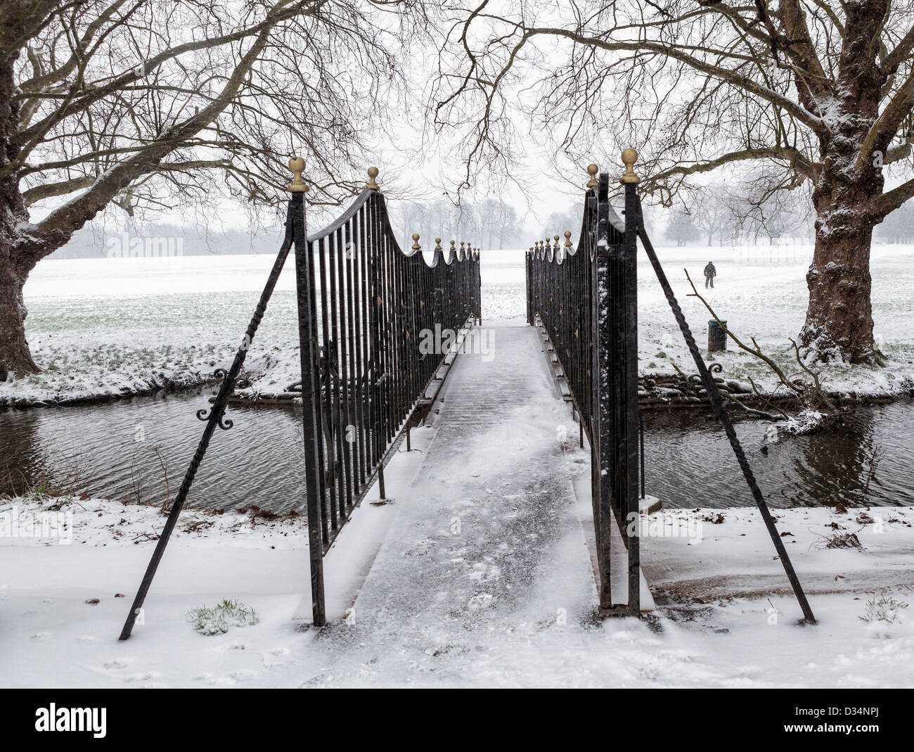 Decorative iron bridge crossing a canal which runs next to the Thames ...