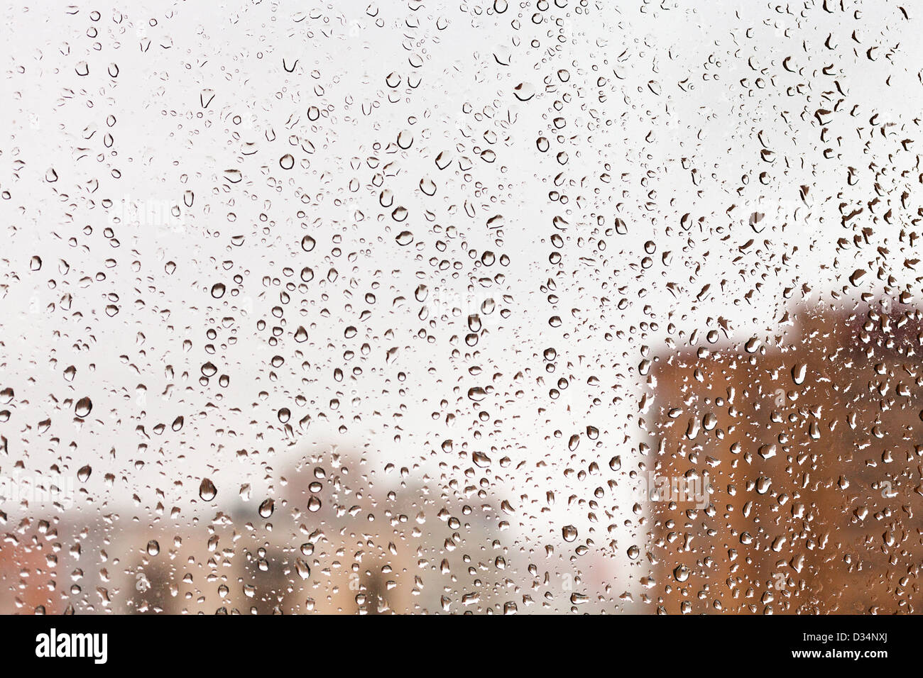 raindrops on glass window with cityscape background Stock Photo - Alamy