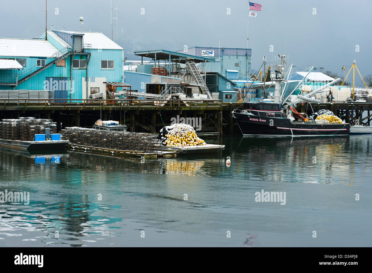 Boats and barge docked at seafood processor in winter, Sitka, Alaska ...