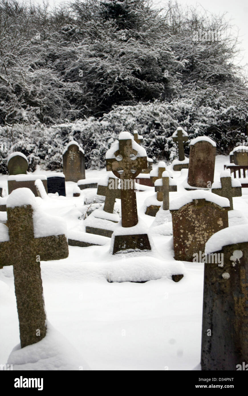 Snow covered gravestones Stock Photo - Alamy