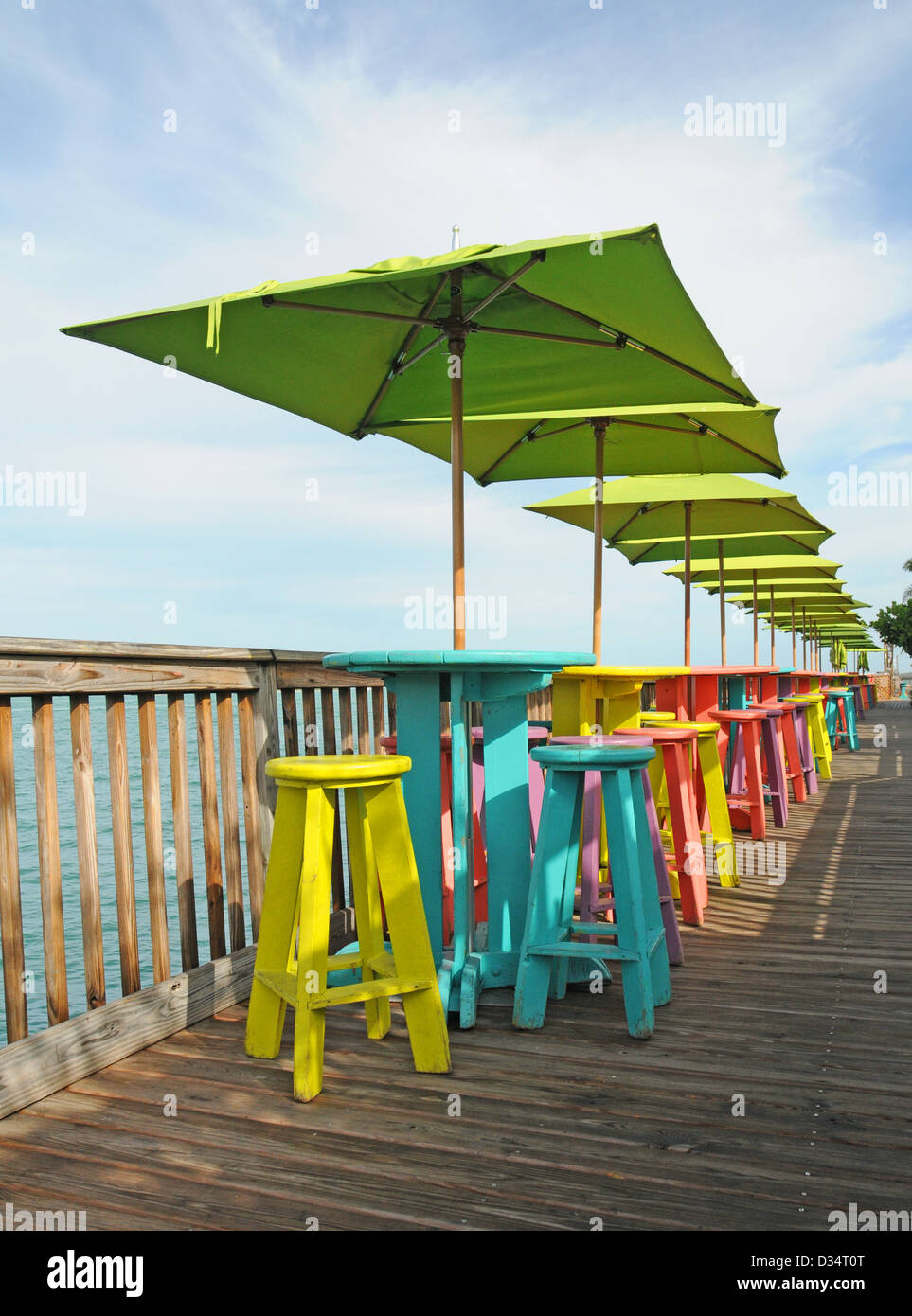 colorful tables and chairs overlooking ocean Stock Photo - Alamy
