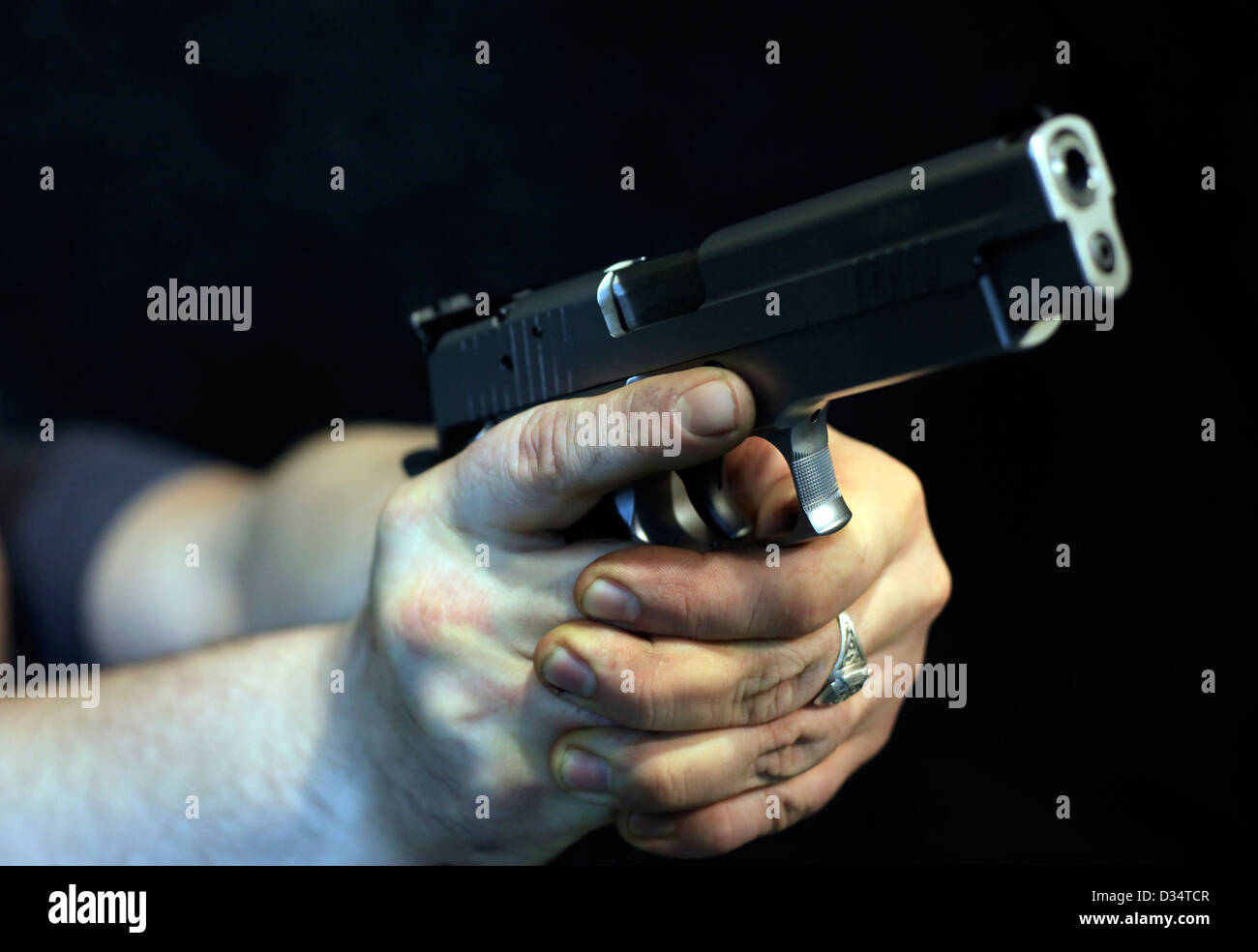 Man's hands with a pistol Stock Photo - Alamy