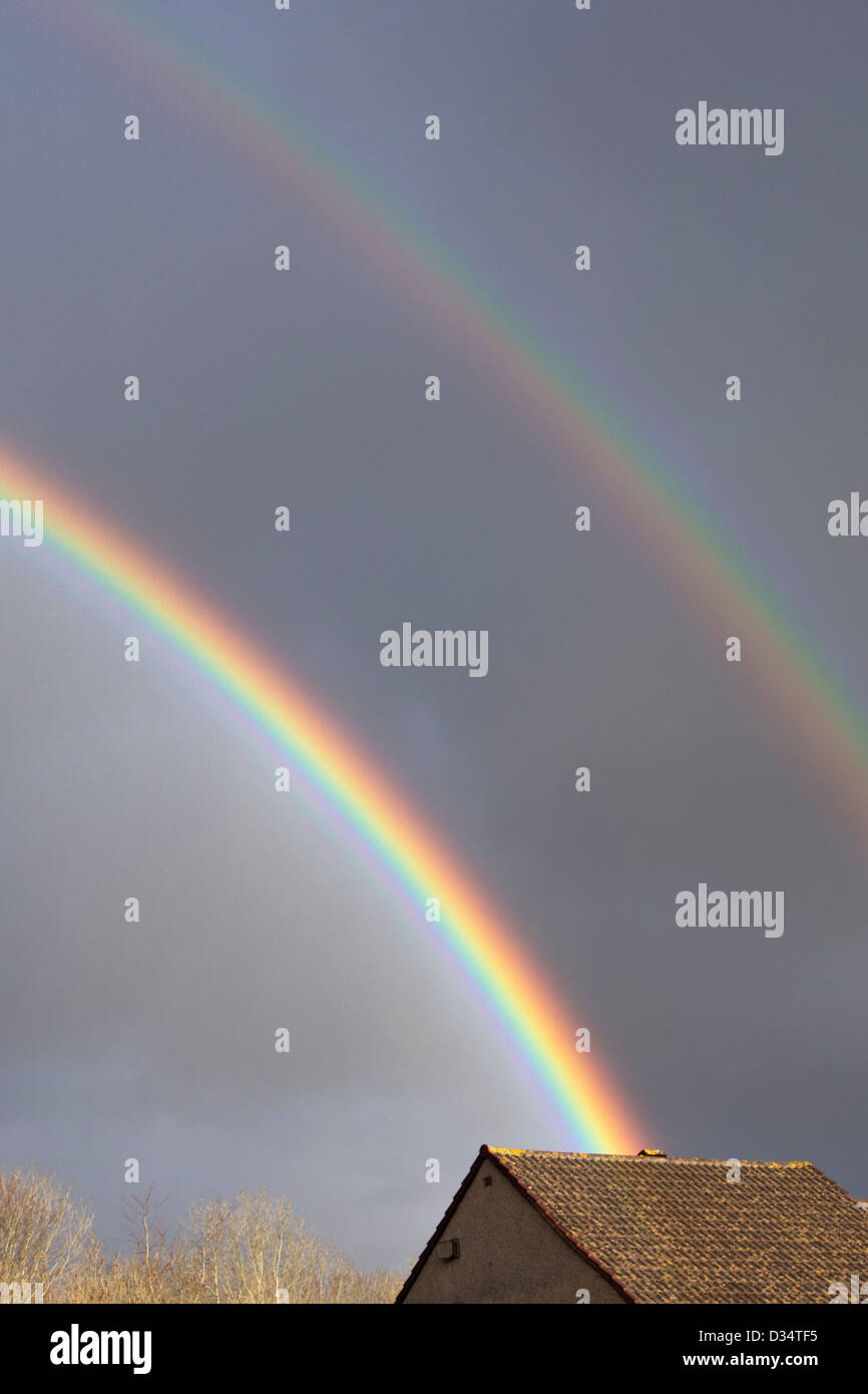Double rainbow over house roof, Devon, UK Stock Photo - Alamy