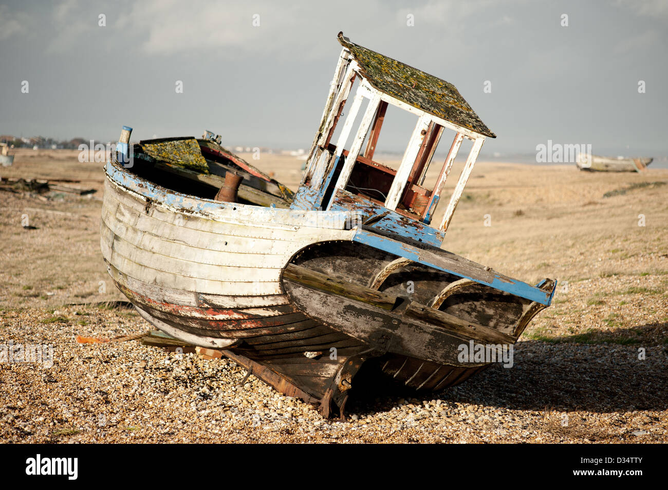 Old wooden fishing boat on the shingle beach at Dungeness in Kent, UK ...