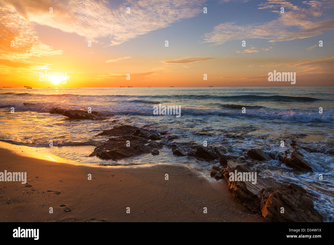 Nice sunset over sea beach Stock Photo - Alamy