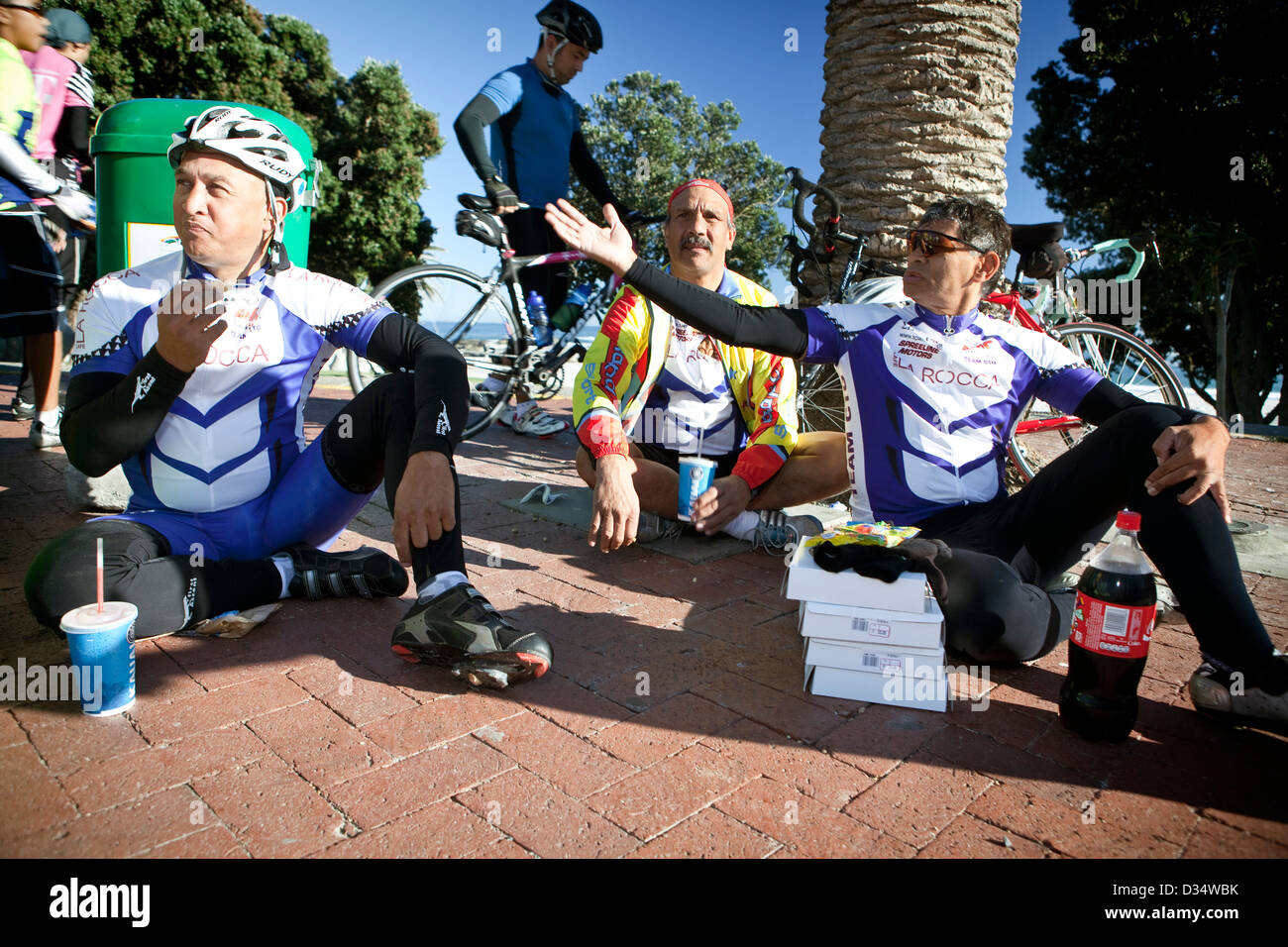 Cyclists sitting and relaxing on the street Stock Photo - Alamy