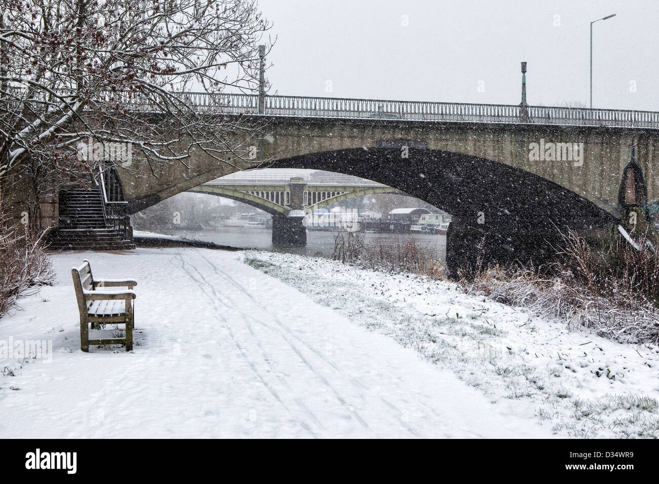Snow covered riverside scene with Two bridges - Twickenham Road Bridge ...