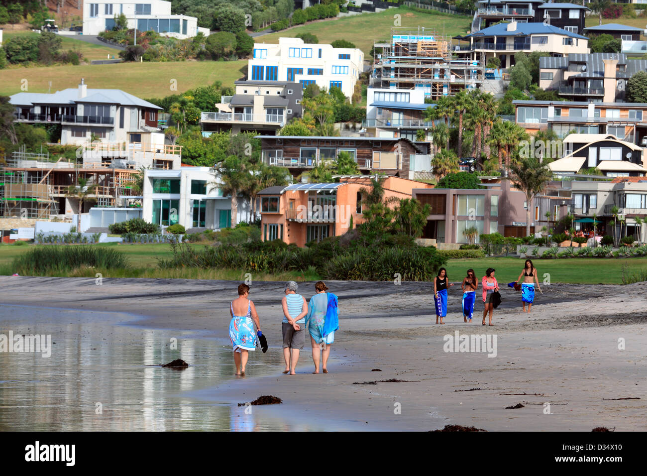 People enjoy summer on Langs Beach in Northland Stock Photo - Alamy