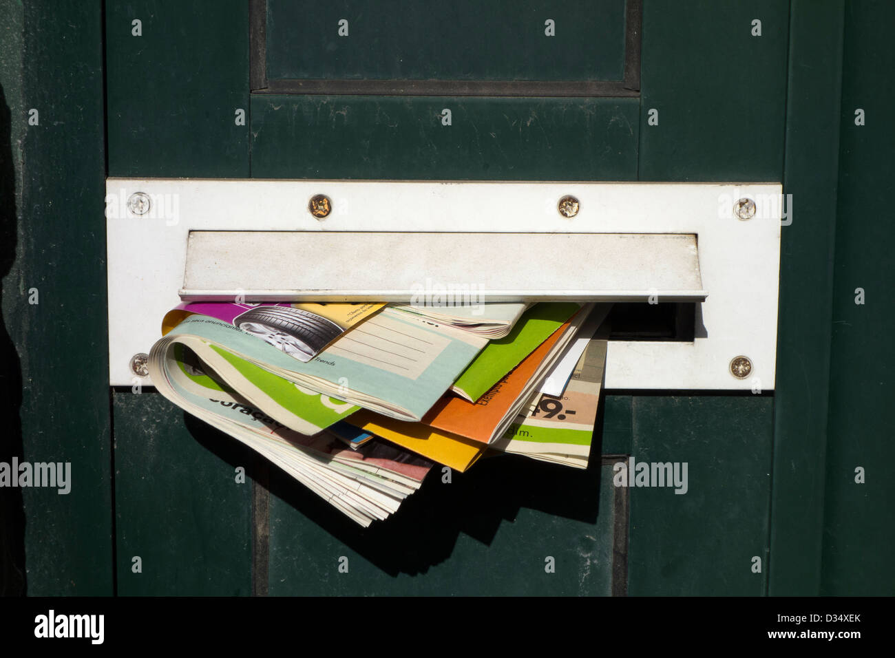 Mailbox filled with junk mail leaflets Stock Photo - Alamy