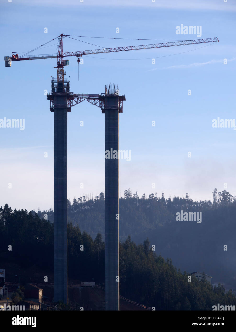 Construction crane building bridge pillars against a blue sky Stock ...