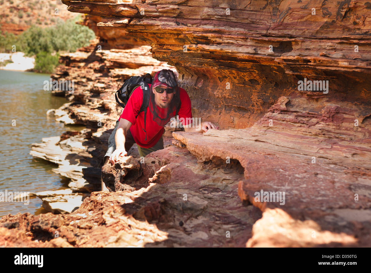 Man sneak along rock edge at Loop walk, Kalbarri national park, Western ...