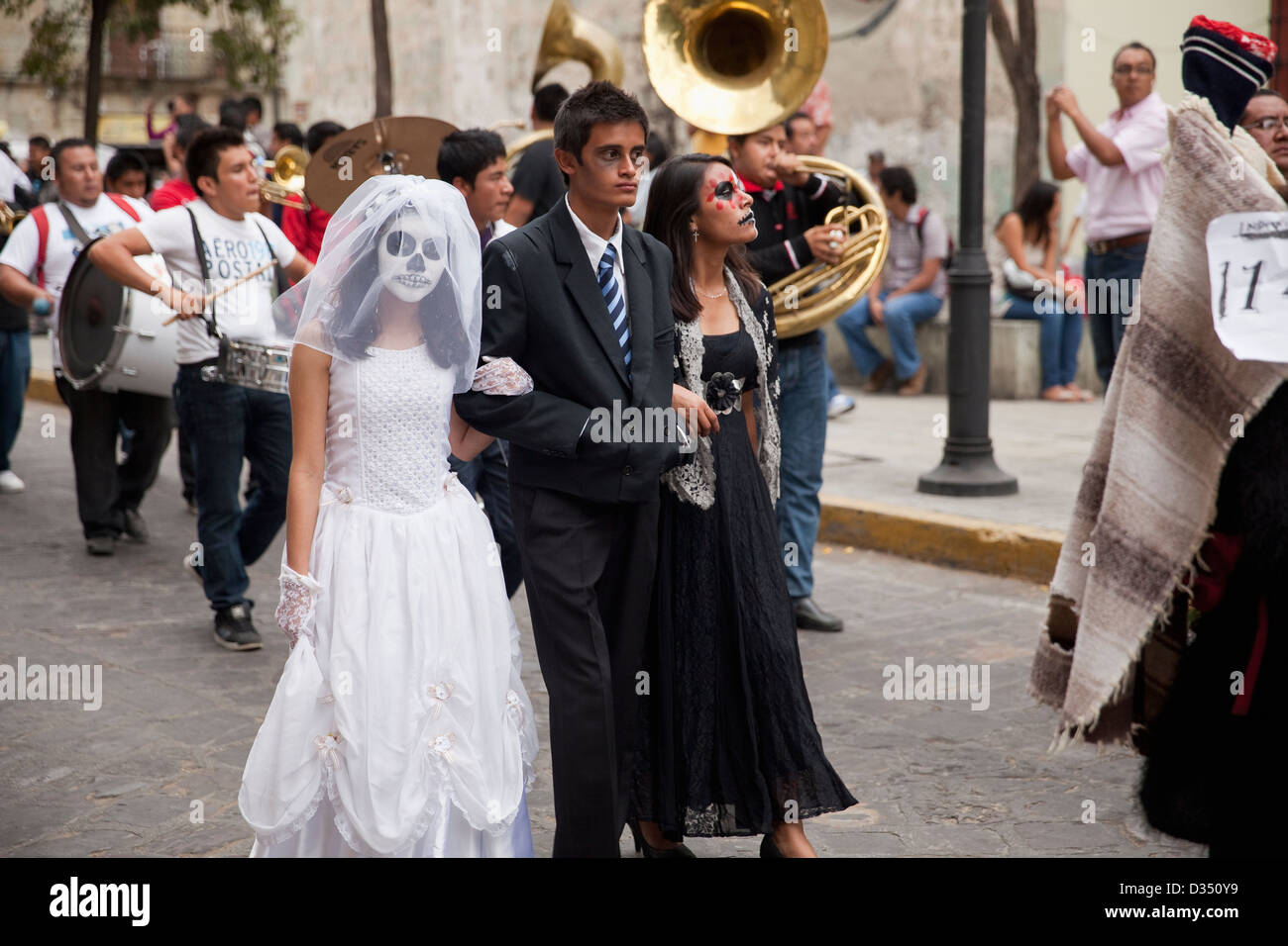 Day of the Dead parade with bride, groom and other participants in ...