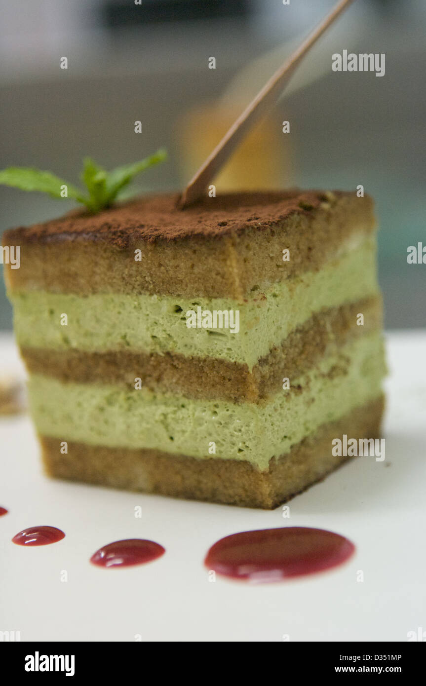 Green tea mousse with raspberry coulis Stock Photo - Alamy