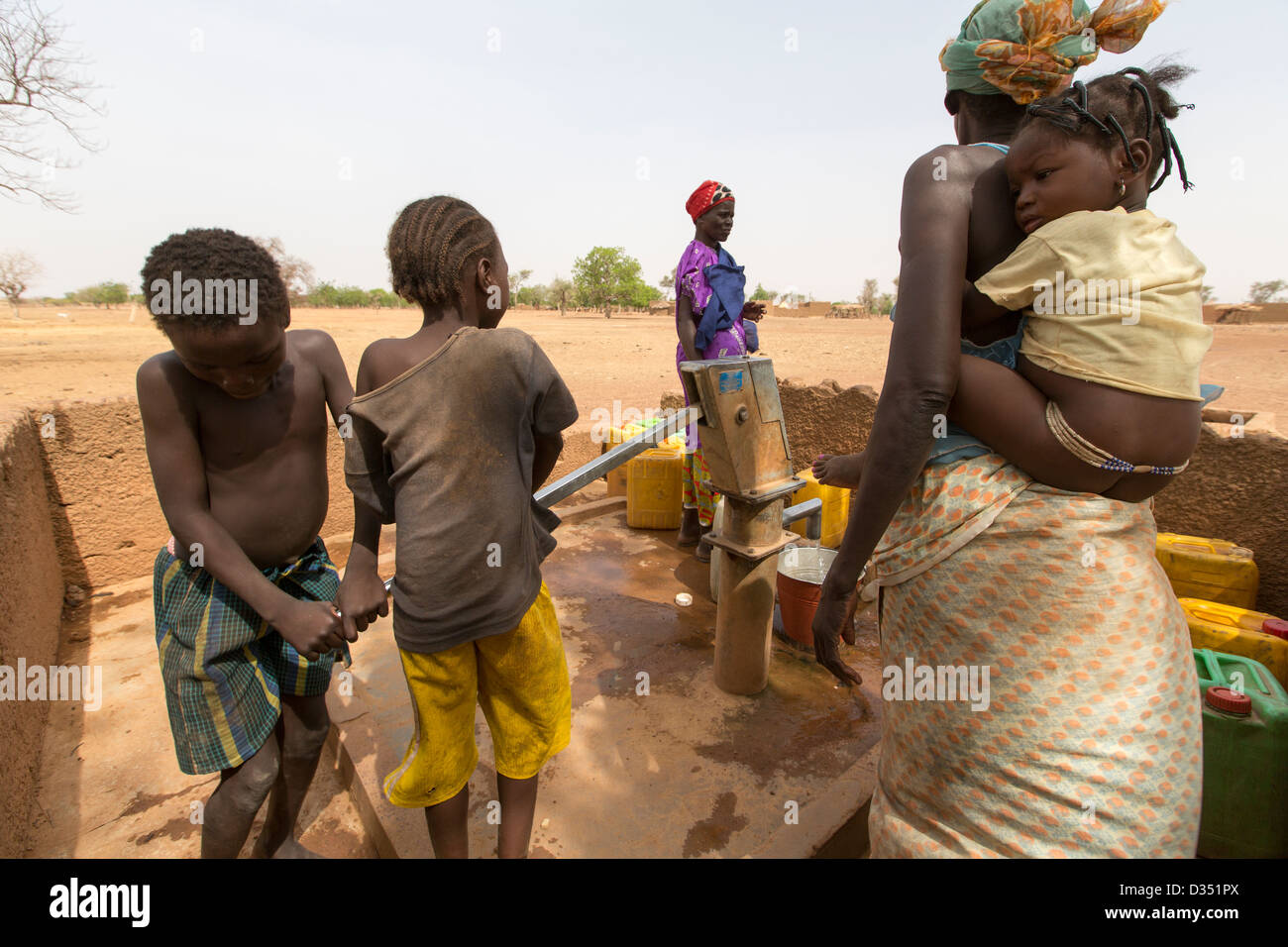 Yako, Burkina Faso, May 2012: Women fetch water from the village ...