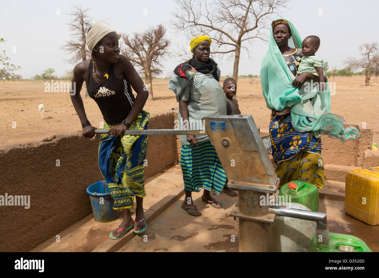 Yako, Burkina Faso, May 2012: Women fetch water from the village ...