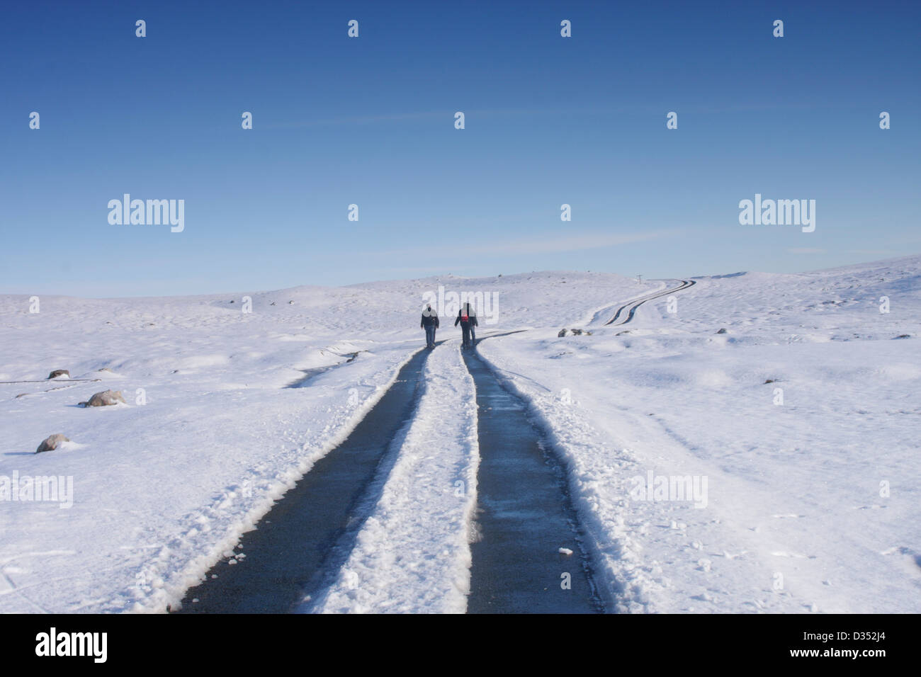 Walkers on snow covered track, Malhamdale, Yorkshire, England, January ...