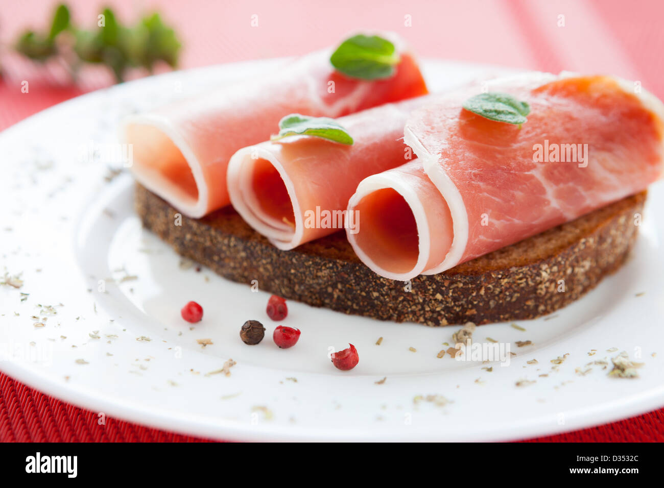 three slices of ham wrapped in a roll, closeup Stock Photo - Alamy
