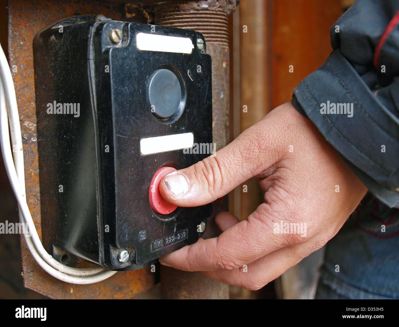 Hand press red button on electric power switch Stock Photo - Alamy