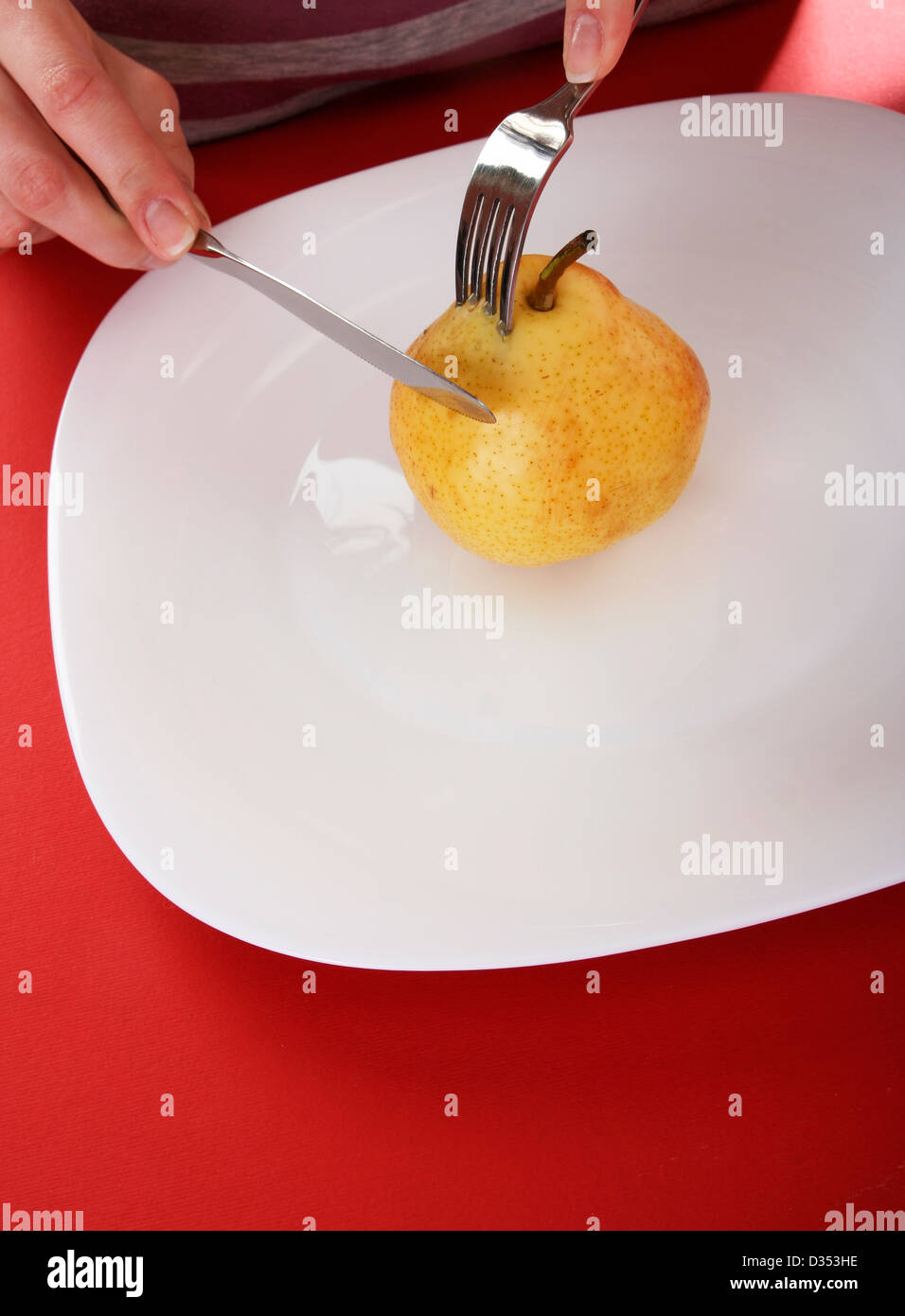 Eating a tasty yellow pear Stock Photo - Alamy