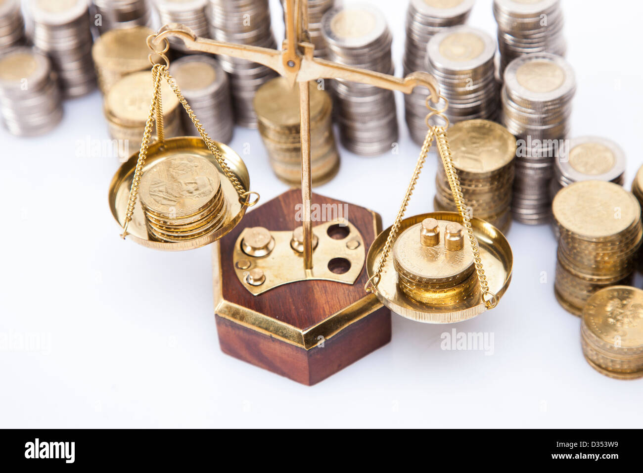 A lot of money! Coins on scales Stock Photo - Alamy