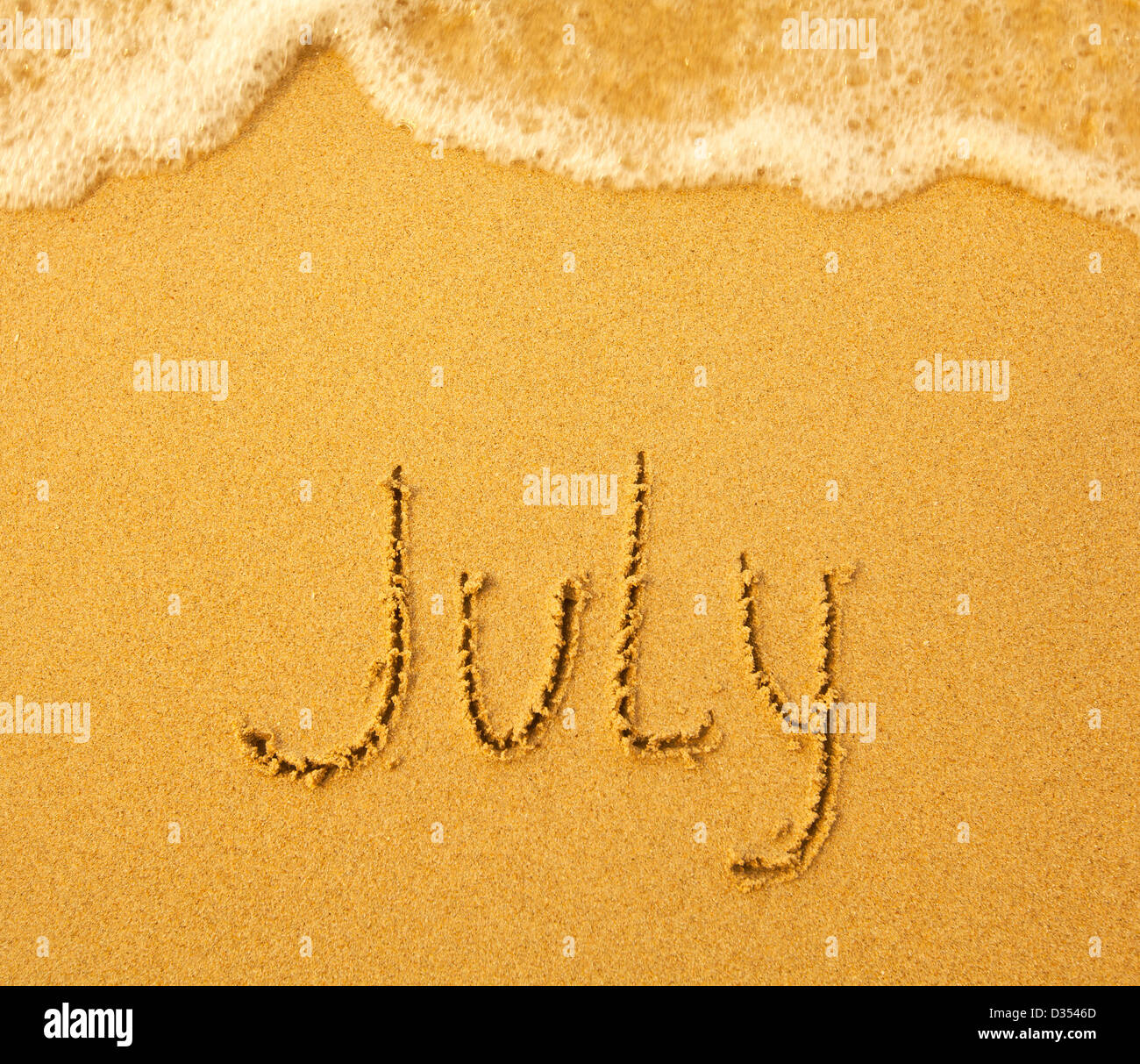 July - written in sand on beach texture - soft wave of the sea (months ...