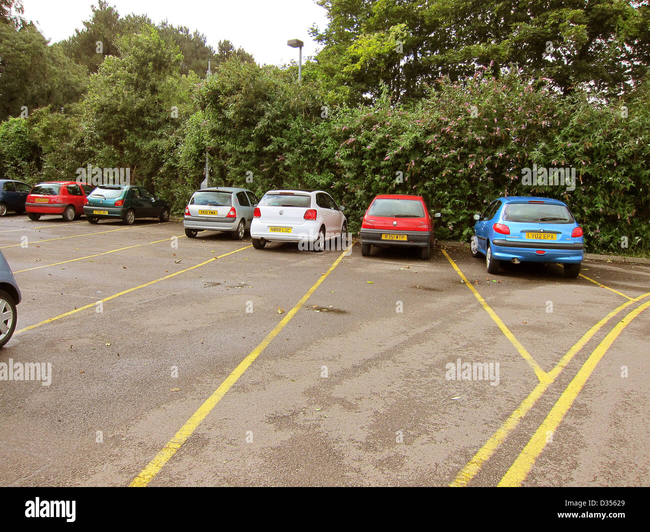 Almost empty little used car park, with only a few cars parked in it ...