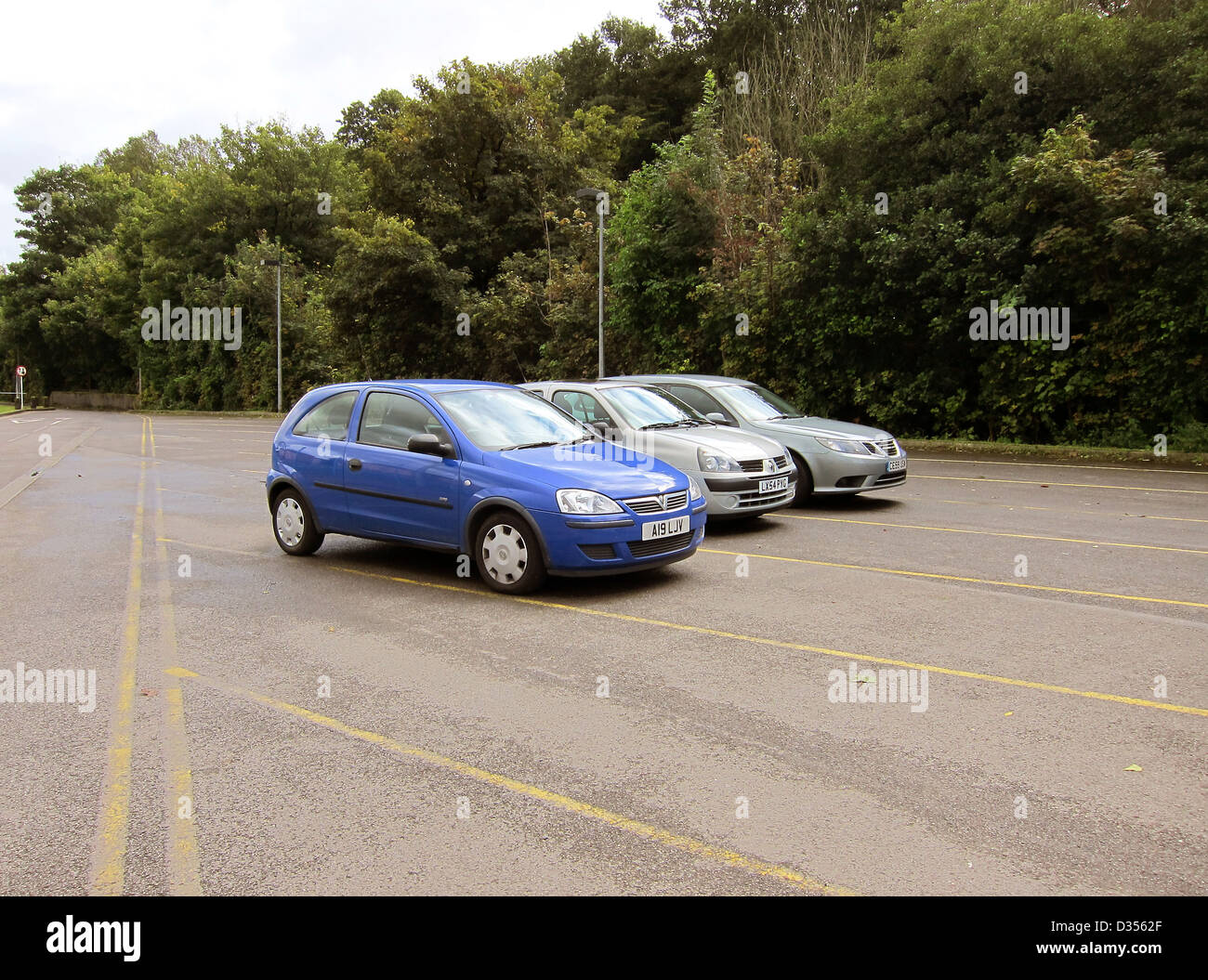 Almost empty little used car park, with only a few cars parked in it ...