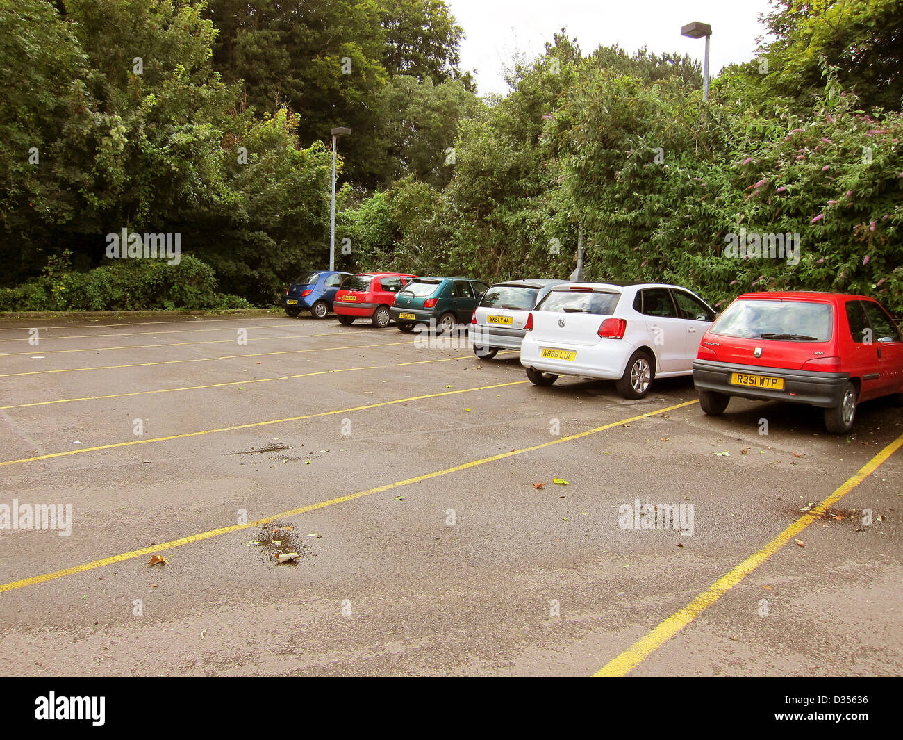 Almost empty little used car park, with only a few cars parked in it ...