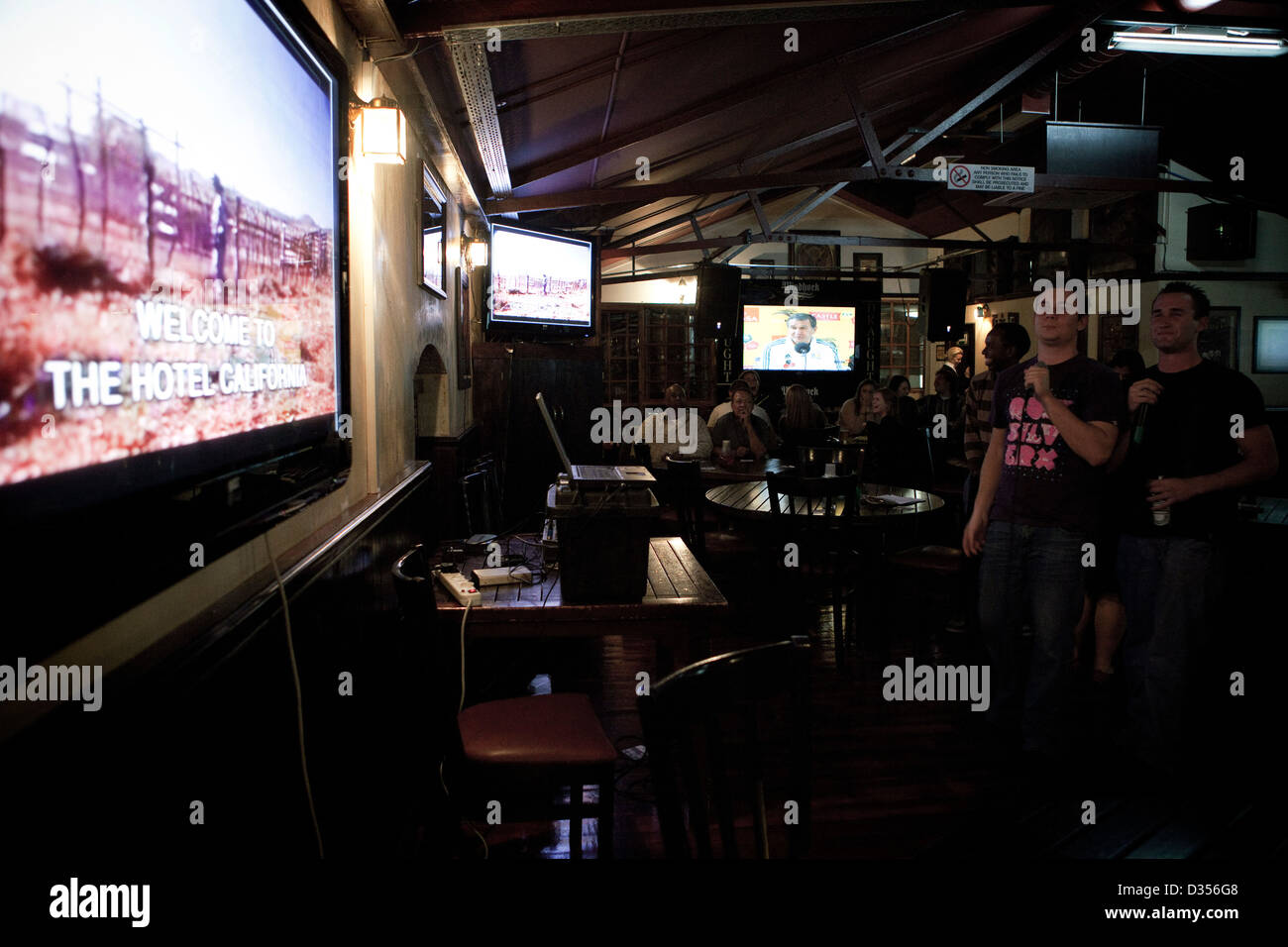 Two men singing karaoke at a bar at the Waterfront in Cape Town Stock ...