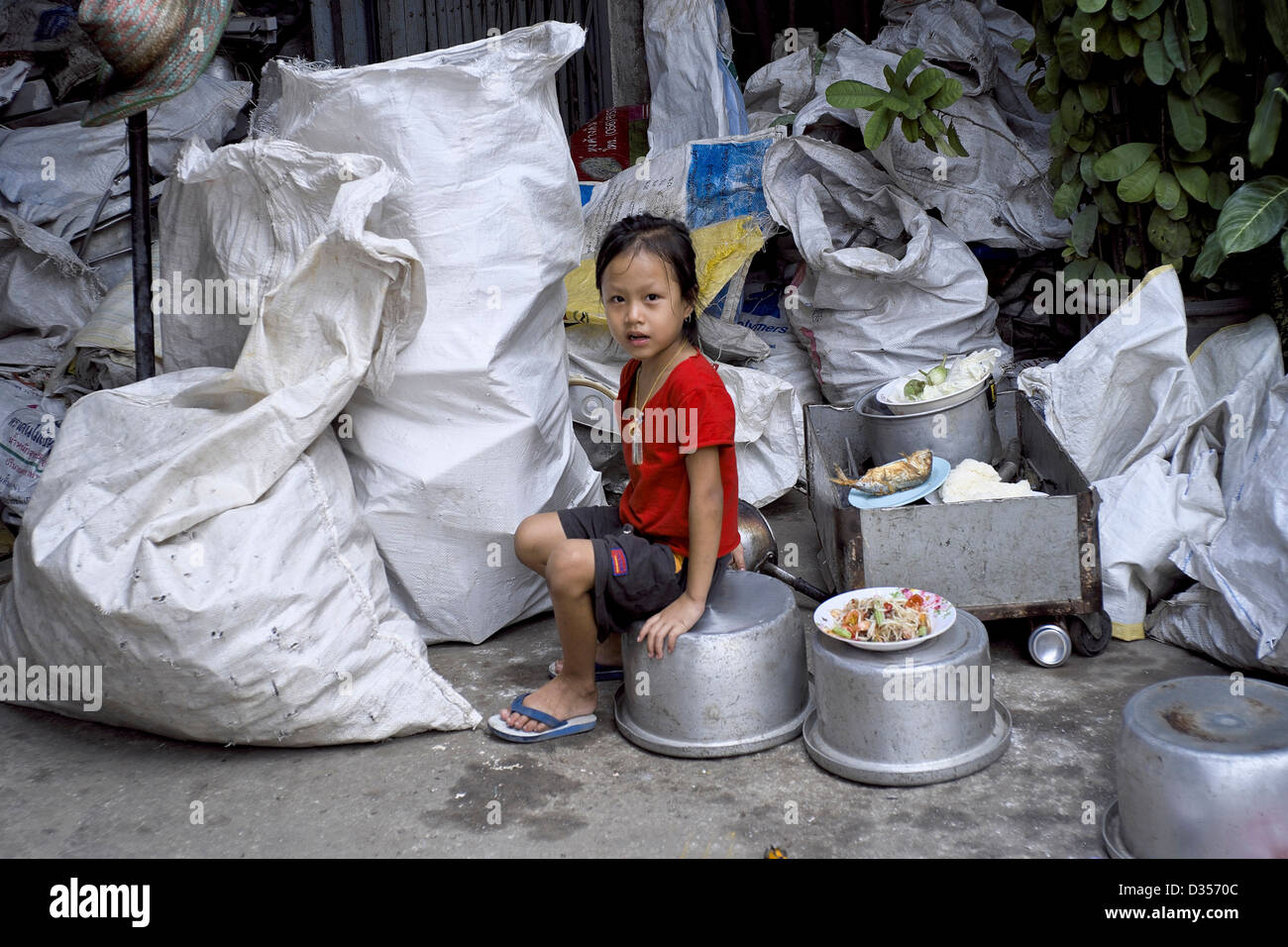 Thailand poverty. Child eating food among the garbage collection in a ...